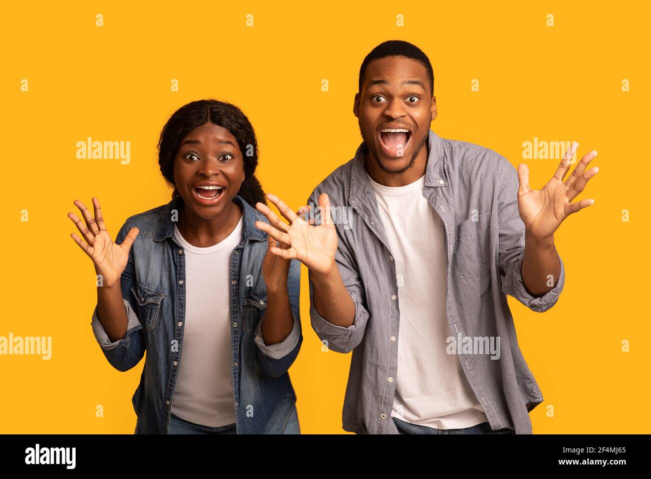 Surprised Black Couple Exclaiming With Excitement And Spreading Hands ...