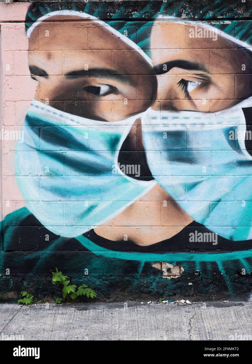 A wall painting mural of two doctors wearing surgical masks or covid19 ...
