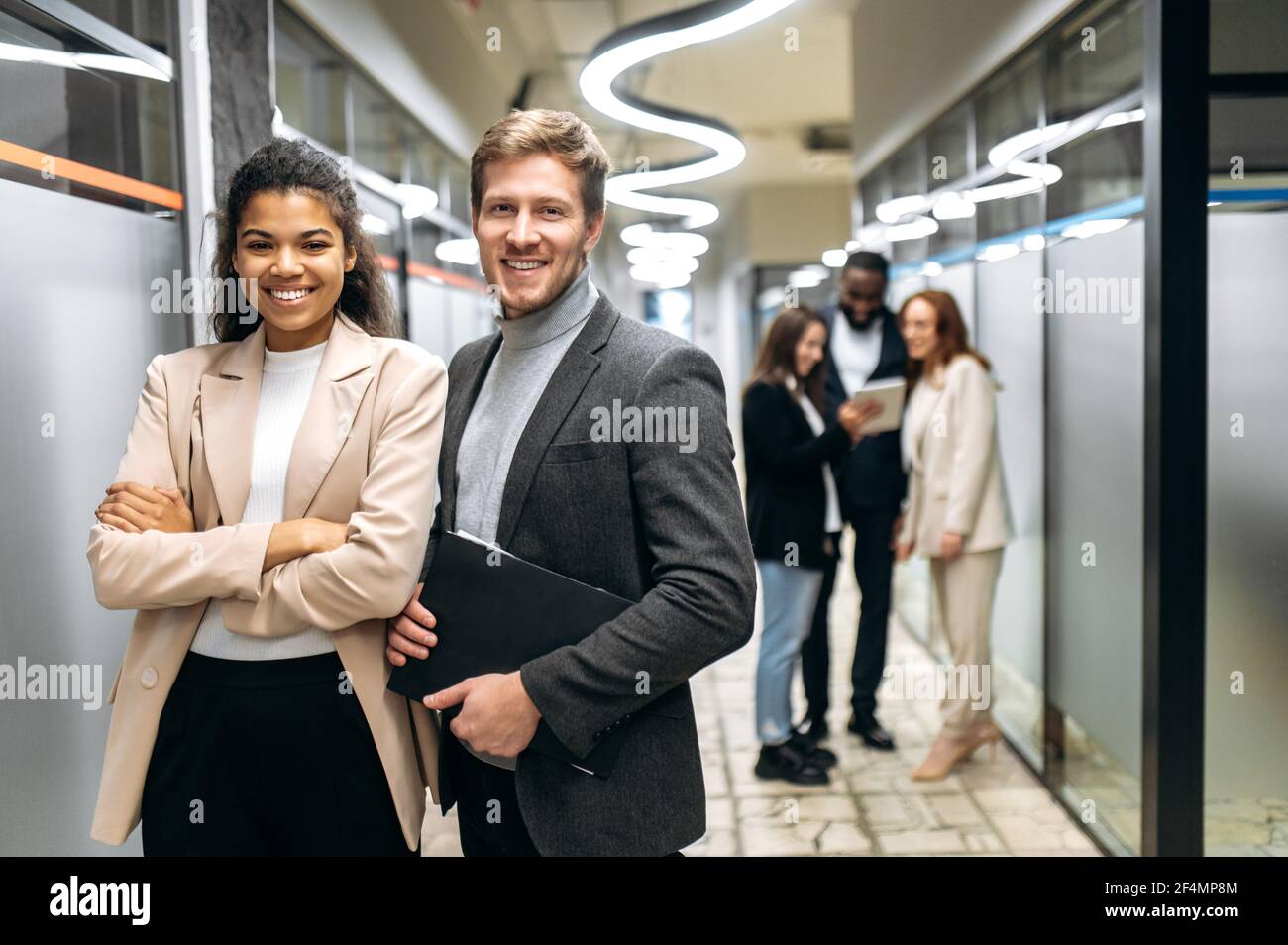 Portrait of successful stylish office employees at the workplace. Happy ...