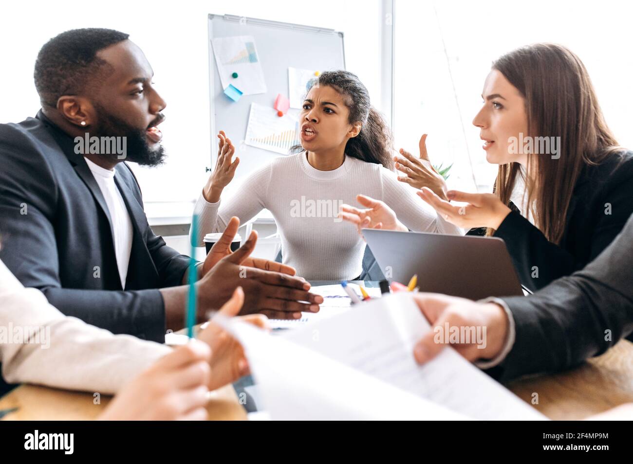 Angry business partners sitting in office on negotiations, cant coming ...