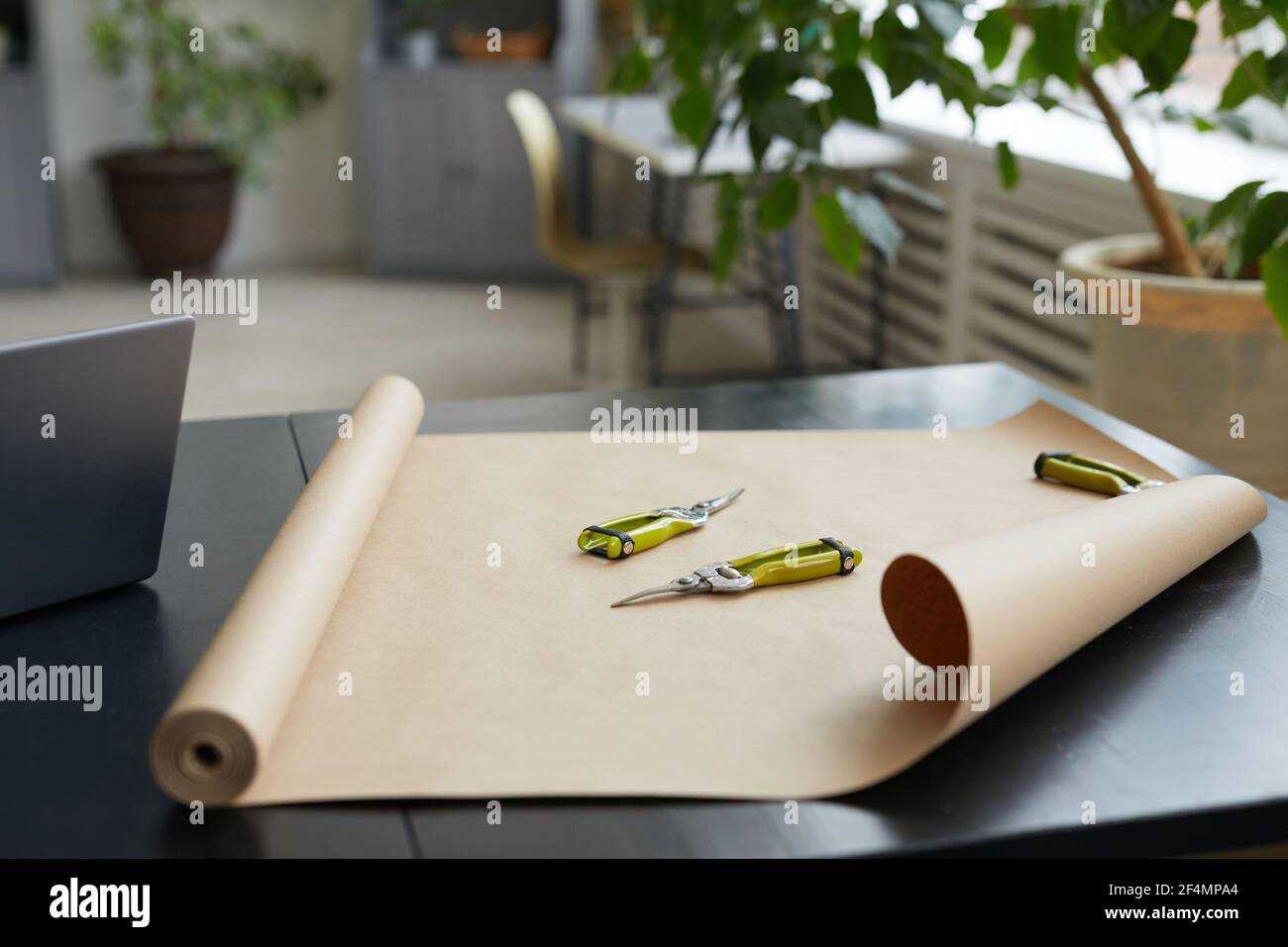 Close up of cutting tools and craft paper on table in florists workshop ...