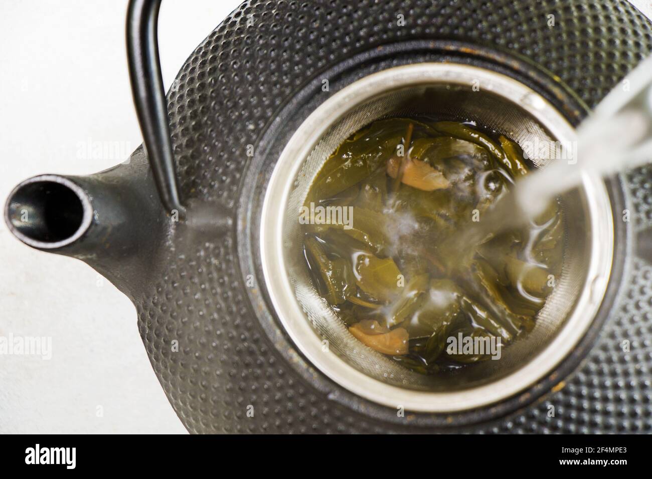 Herbal tea, iron teapot and cup of tea on the white background, chinese ...