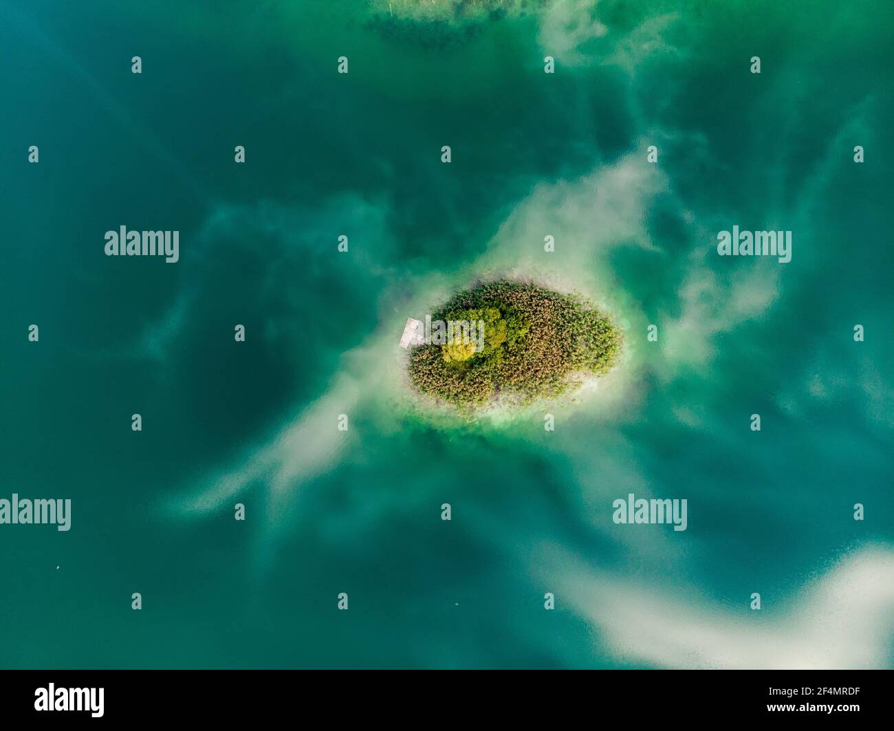 Aerial top down view of small island. Birds eye view of beautiful green ...
