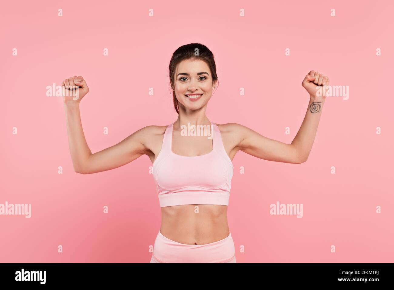 Attractive female showing muscles hi-res stock photography and images ...