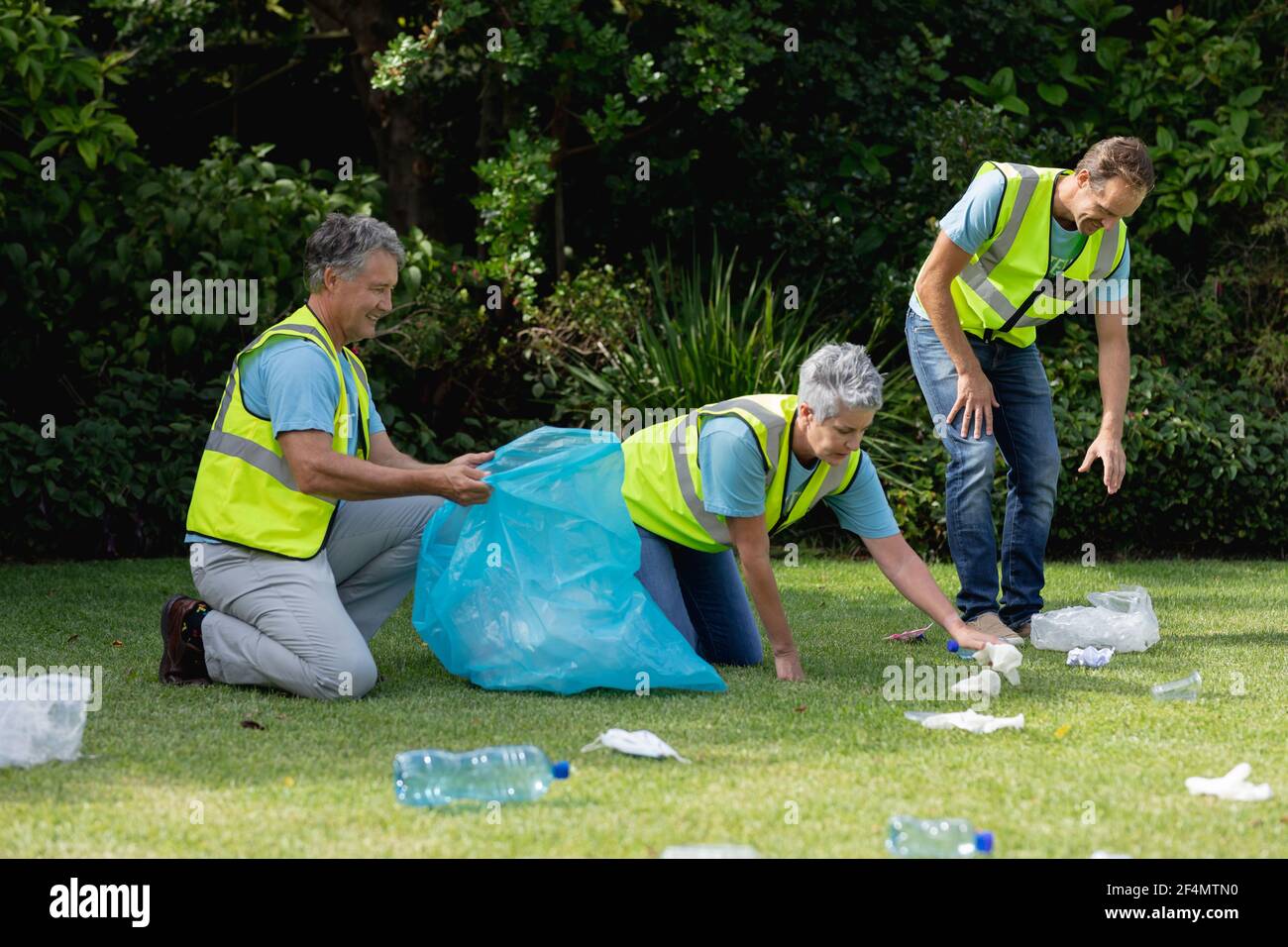 Caucasian multi generation group of men and women collecting rubbish in ...