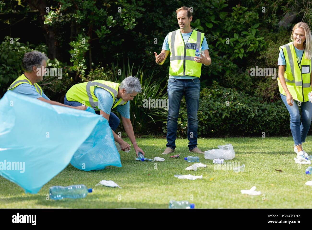 Caucasian multi generation group of men and women collecting rubbish in ...