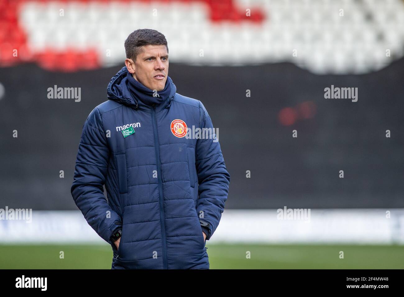 Football coach Alex Revell stands on touchline during game at Lamex ...
