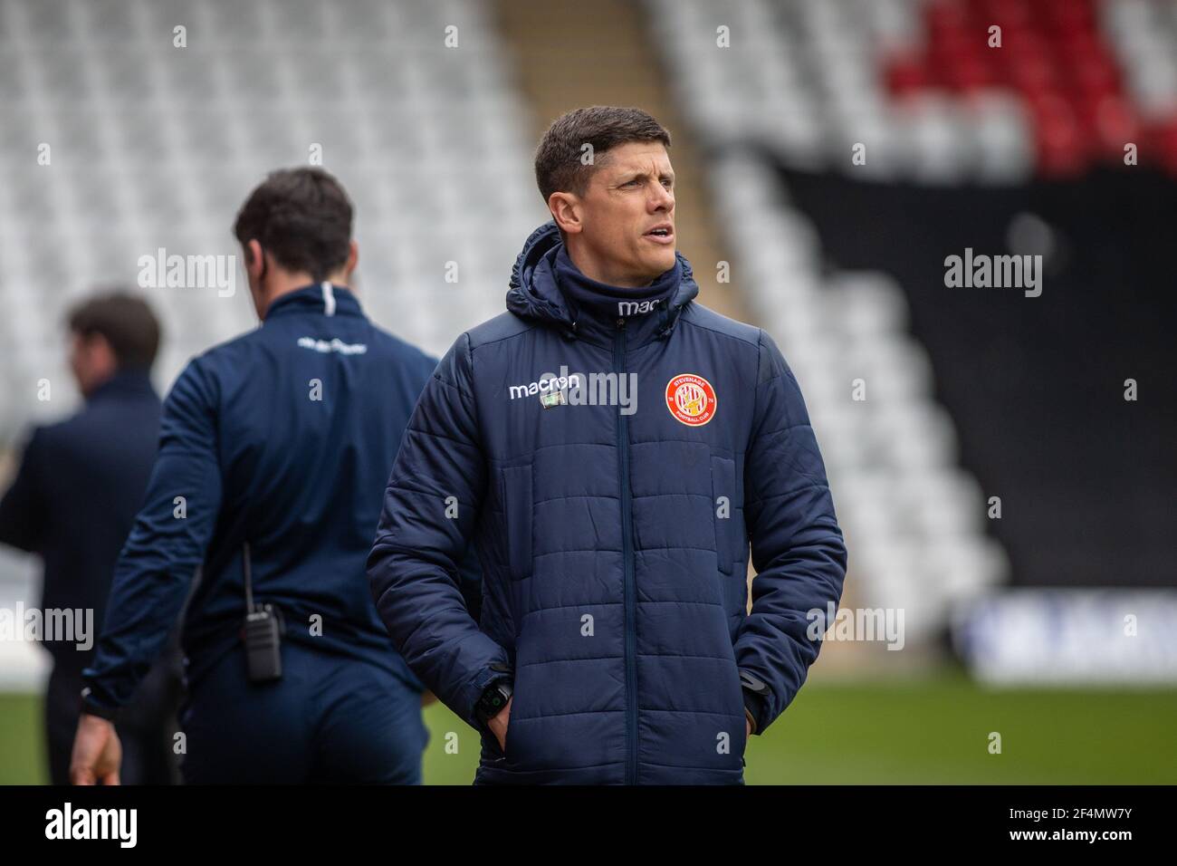 Football coach Alex Revell stands on touchline during game at Lamex ...