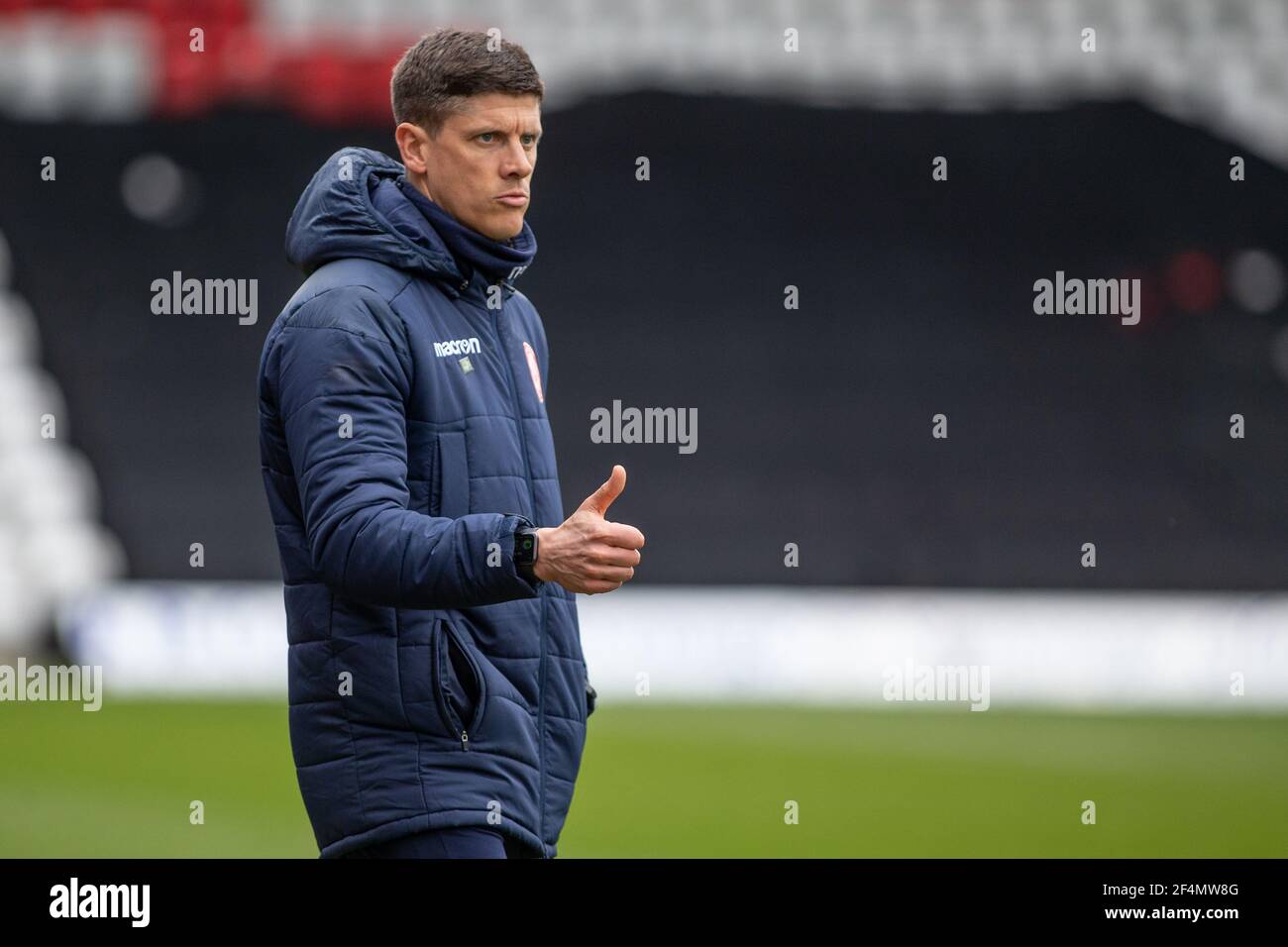 Football coach Alex Revell stands on touchline during game at Lamex ...