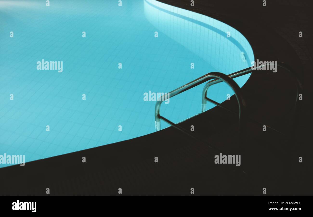 Stairs of an indoor pool with clear water Stock Photo - Alamy