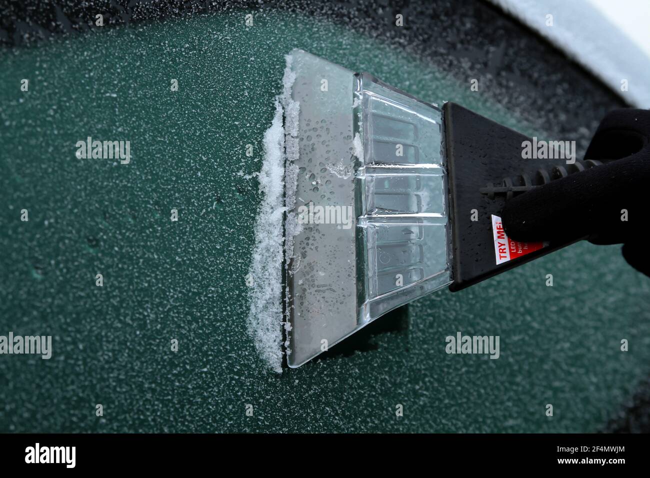 scratching a frozen windshield Stock Photo - Alamy