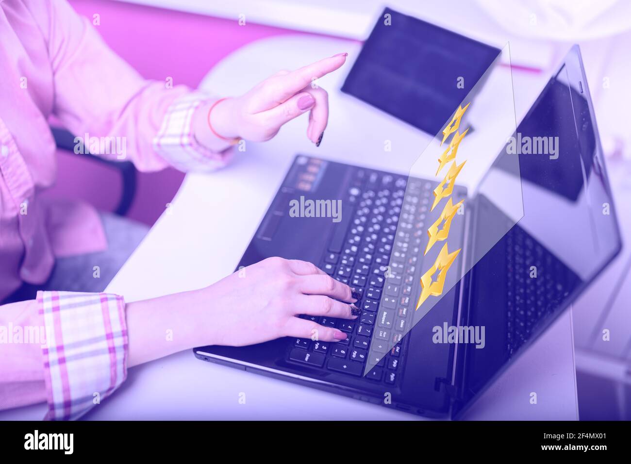 A Woman clicks on a gold 5 five star rating with writing online review ...