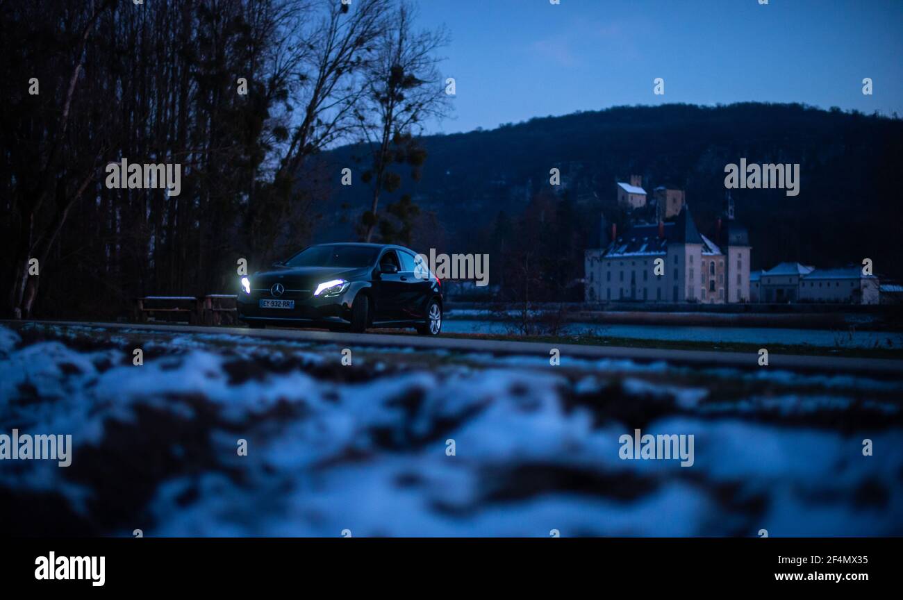 Epic night view of premium Mercedes Benz car in front of a castle near ...
