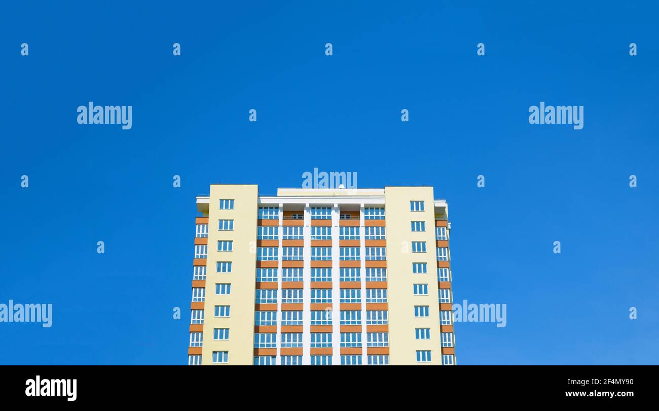 Beautiful top of a new multi-storey building against the blue sky ...