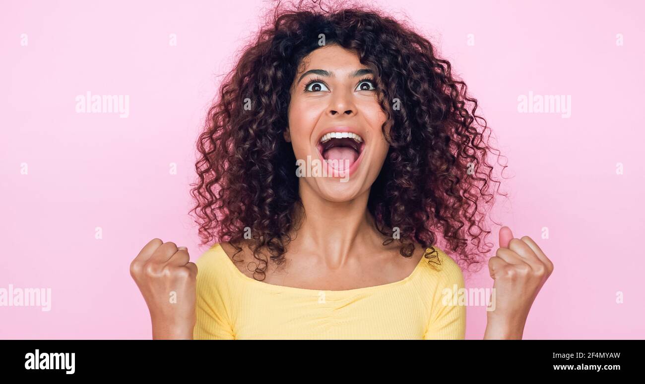 Woman celebrating success on yellow hi-res stock photography and images ...