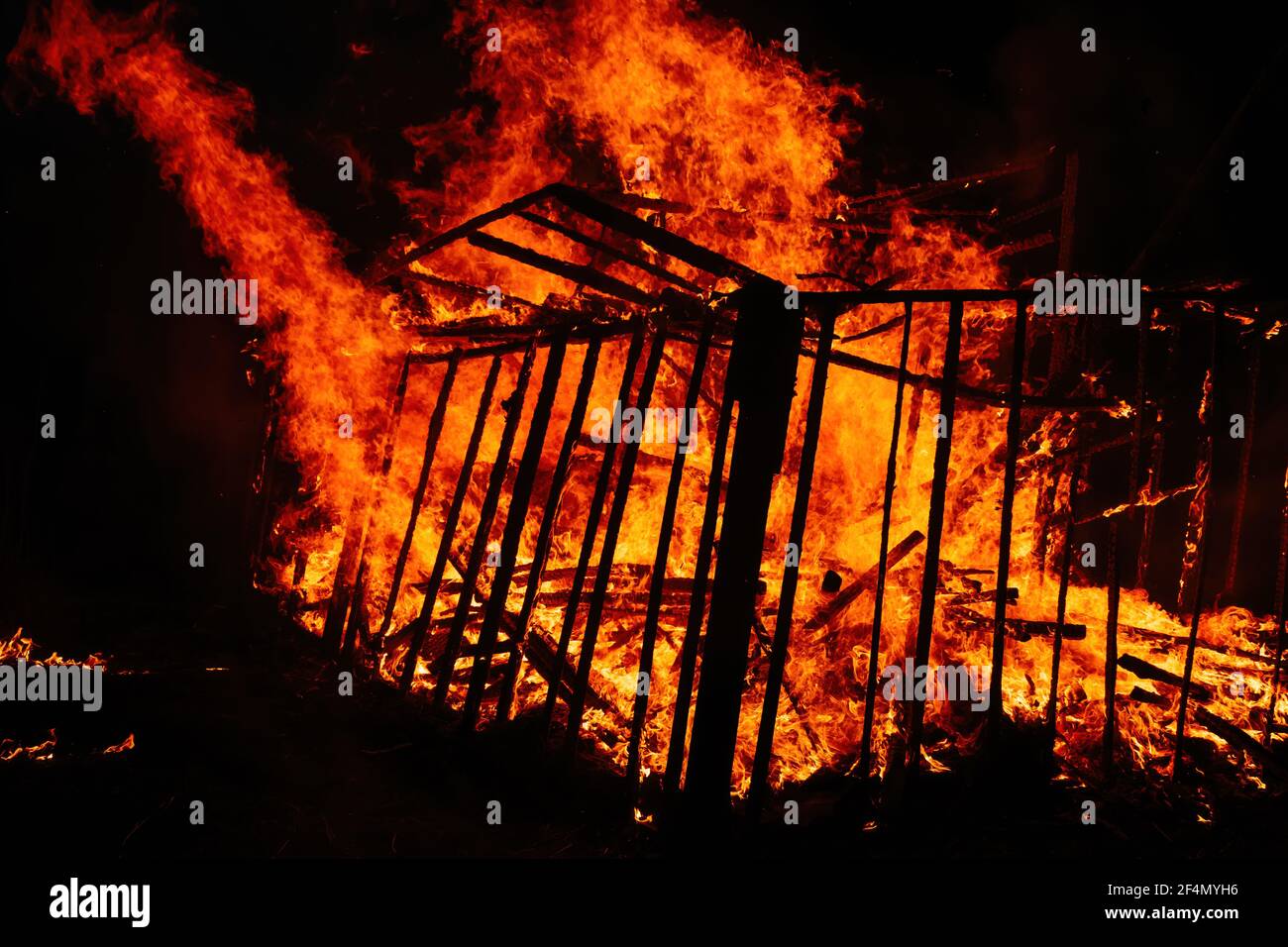 Burning wooden building at night, close up view Stock Photo - Alamy