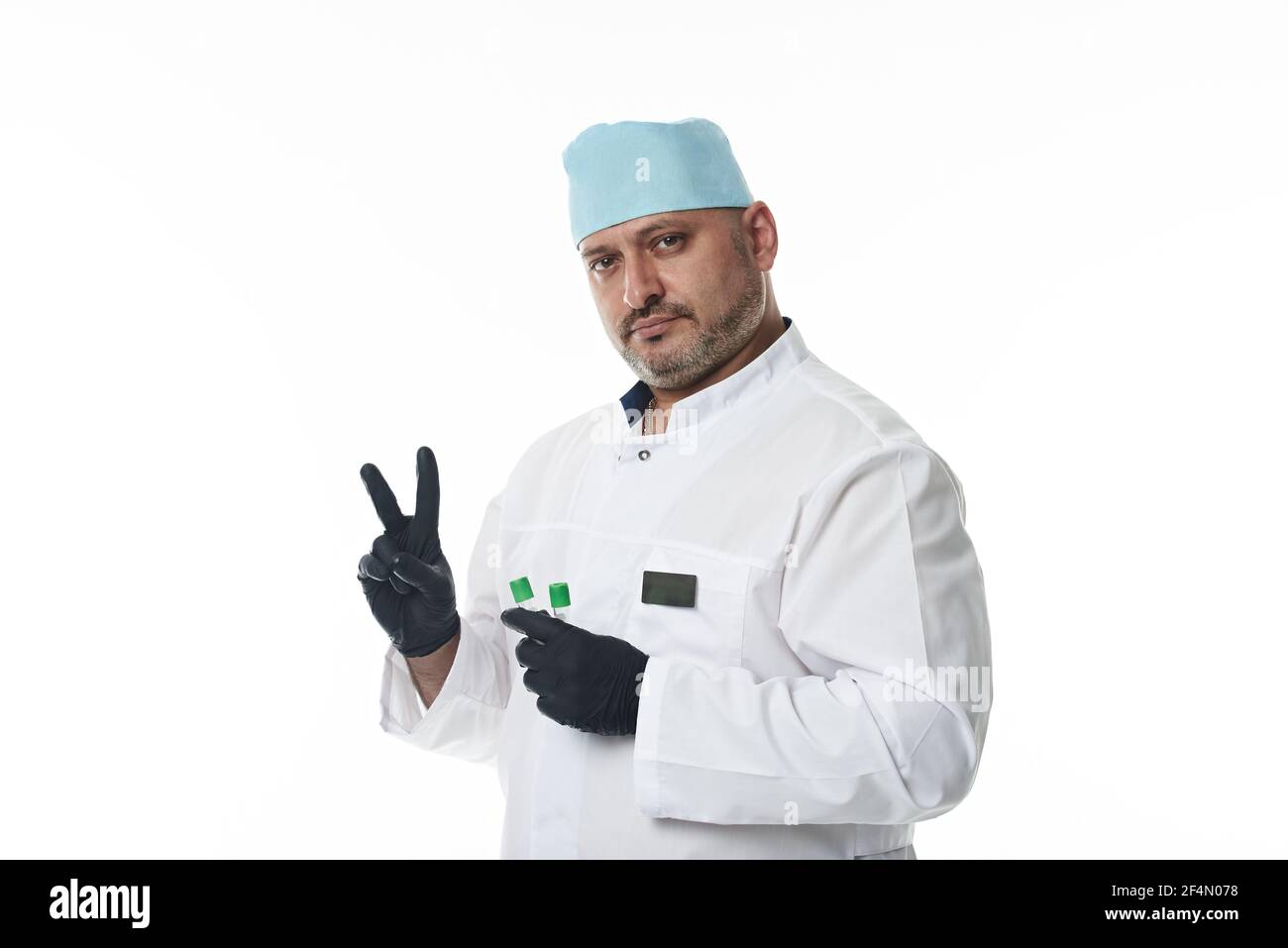Confident portrait of handsome doctor in medical uniform, looking at ...
