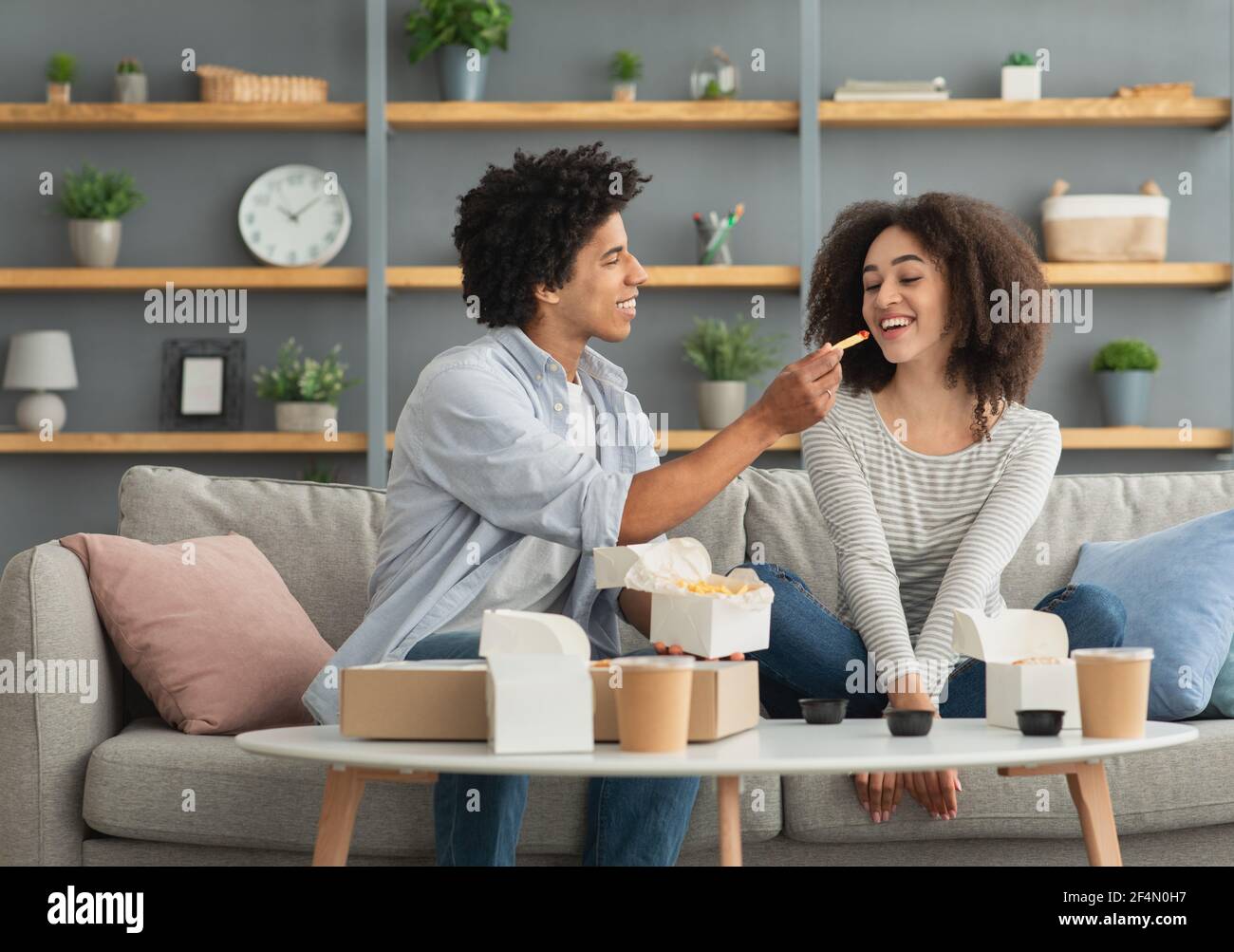 Fun together, dinner at home and food delivery, date Stock Photo - Alamy