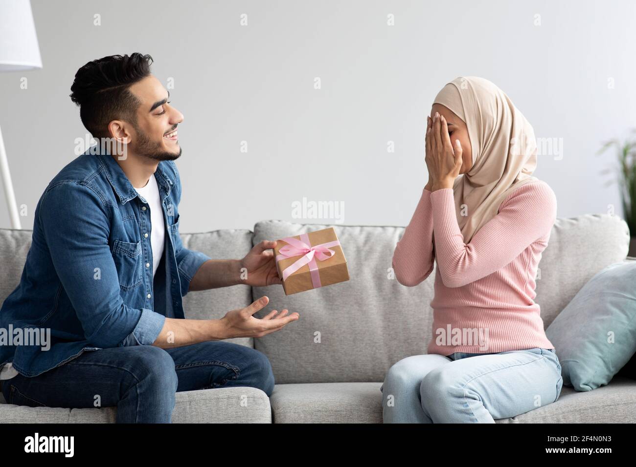 Loving middle-eastern man giving present to his wife Stock Photo - Alamy