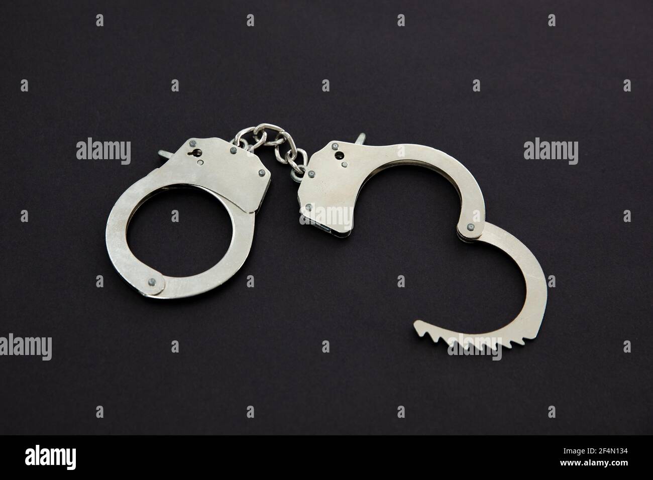 Closeup shot metal handcuffs hi-res stock photography and images - Alamy