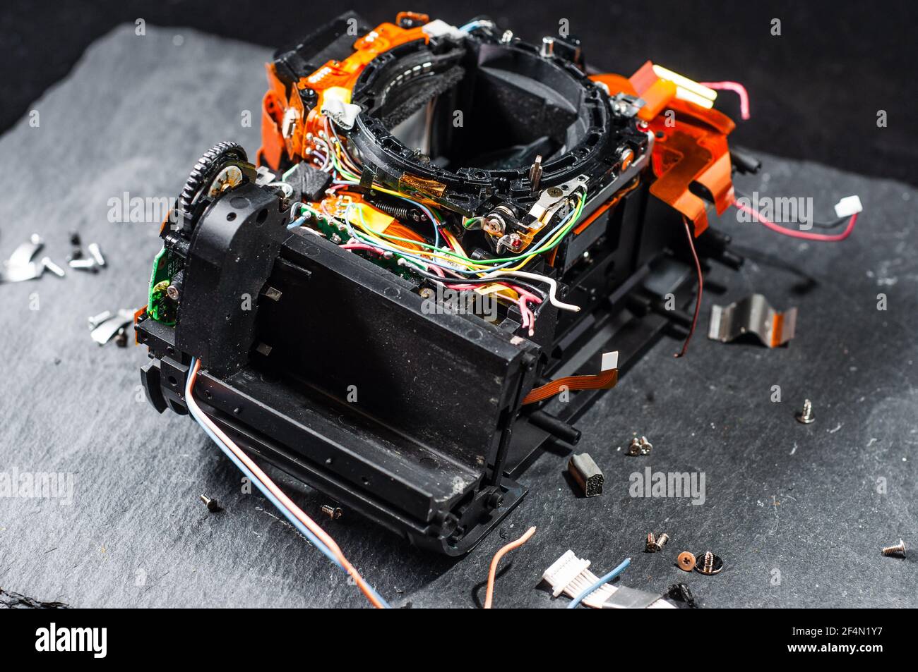 The disassembled camera lies on the subject table in the repair service ...