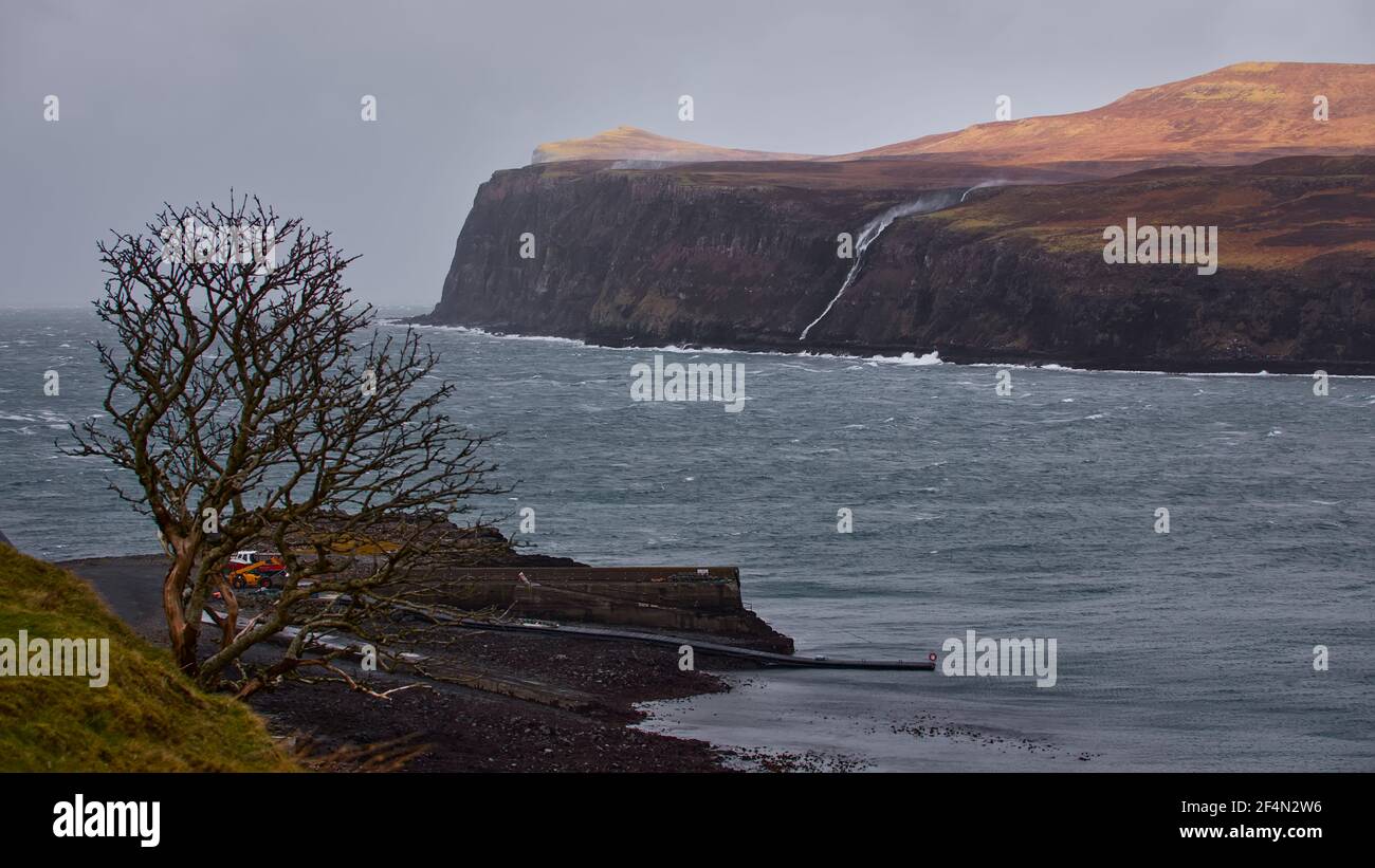 waterfall on cliff in windy day with spray of water going back towards ...