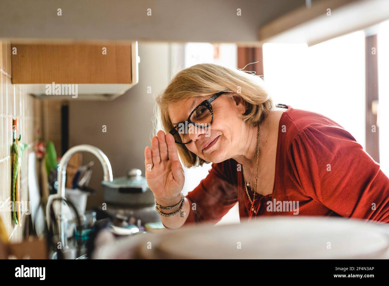 Senior woman cooking lunch in the kitchen - Mature woman in the kitchen ...