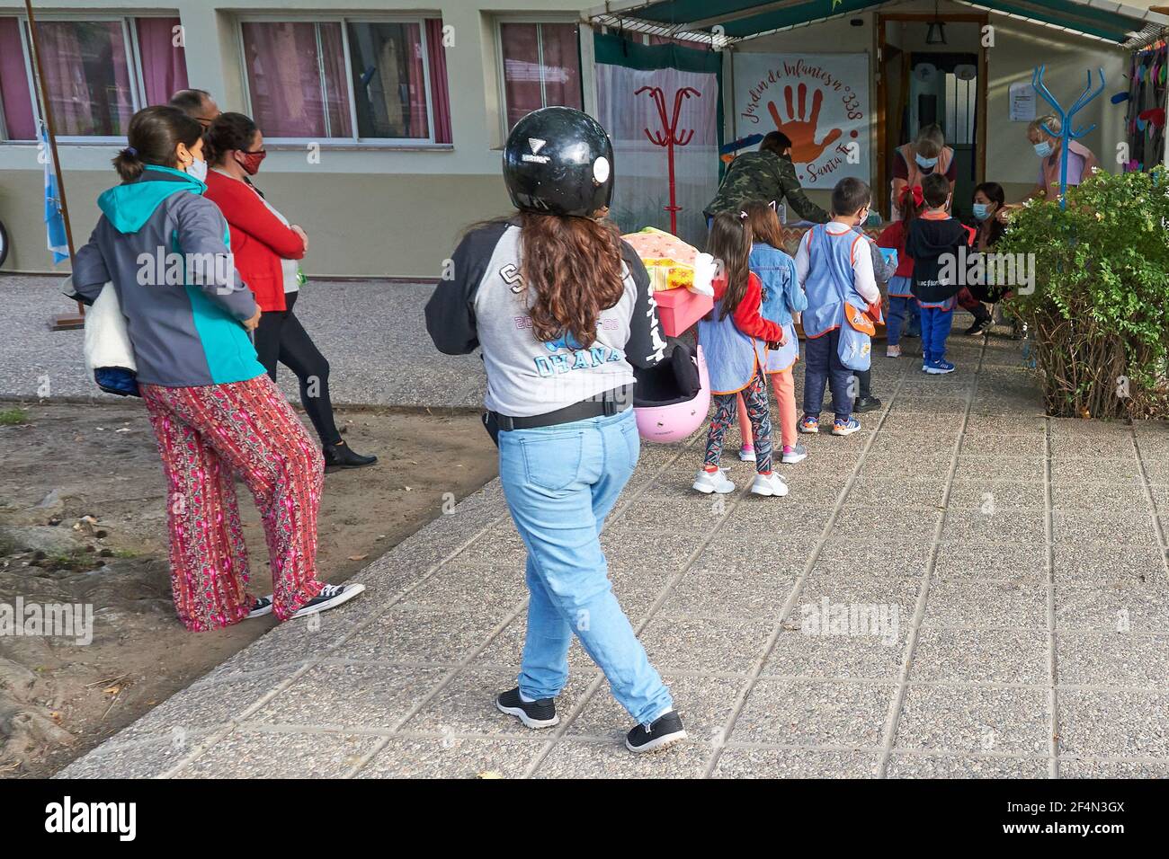 Preschool children queue to wash their hands and have their temperature ...