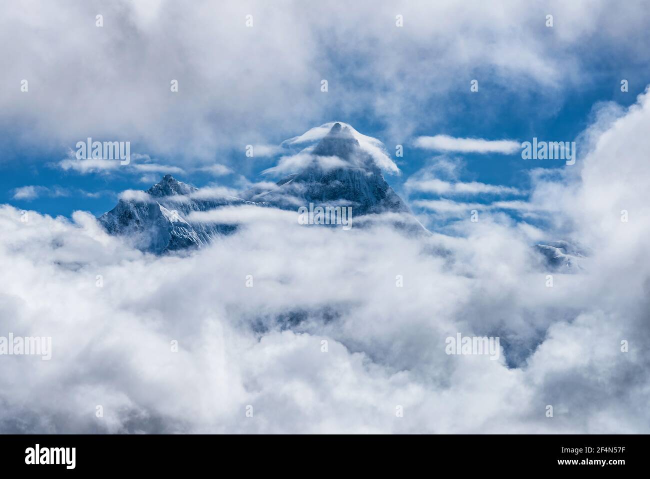 Namcha Barwa Peak in the clouds Stock Photo - Alamy