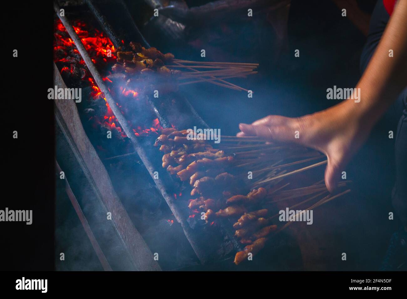 Chicken satay grill at a busy street food market Stock Photo - Alamy