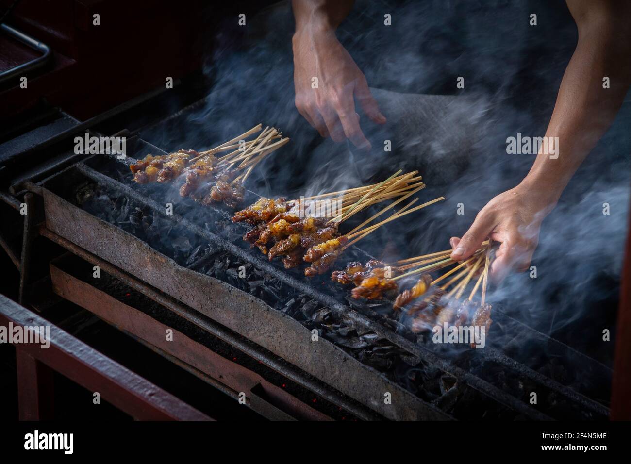 Chicken satay grill at a busy street food market Stock Photo - Alamy