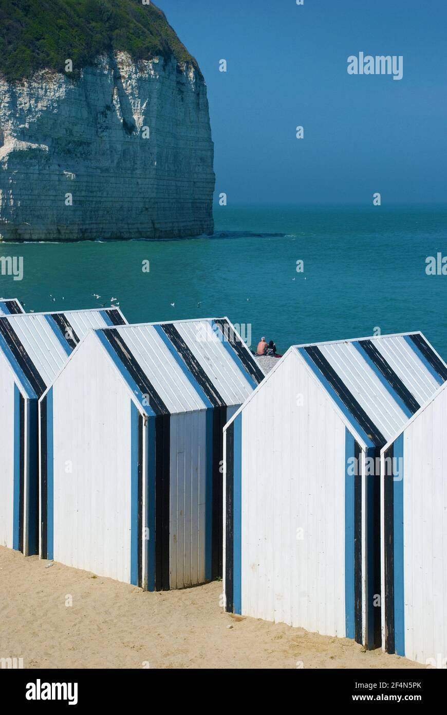 Vacation in Yport with blue and white fishermen's huts on the beach and ...