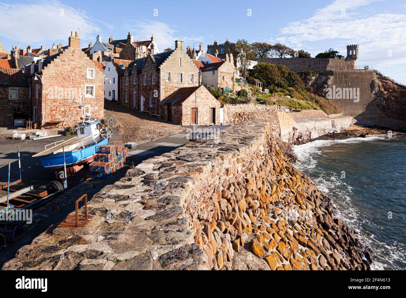 Morning light on the harbour in the small fishing village of Crail in ...