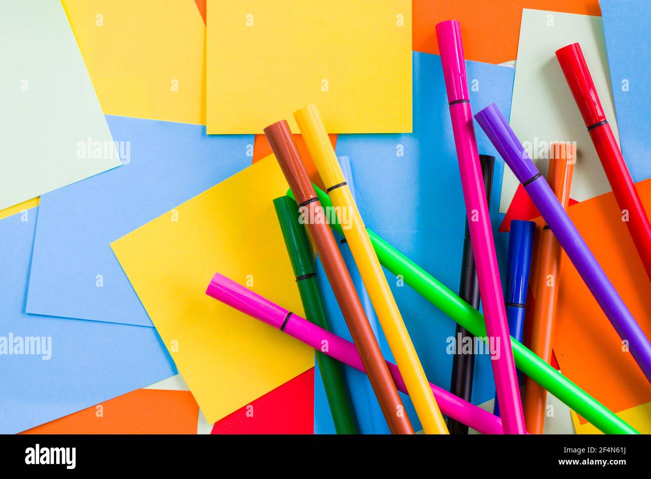 Sketch markers on the colorful paper background, paper board and empty ...