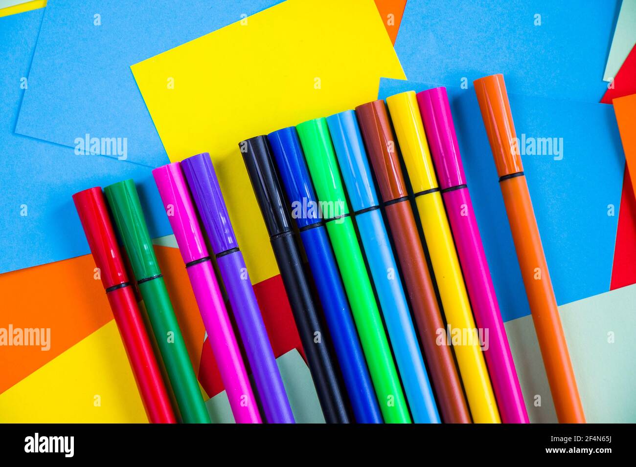 Sketch markers on the colorful paper background, paper board and empty ...