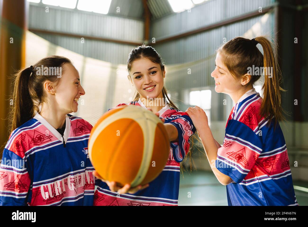 Girls play basketball on court. Sport woman with professional ball ...