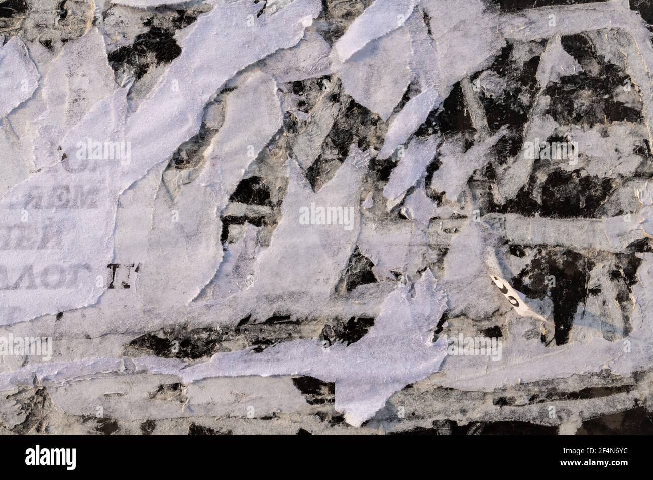 Old advertising billboard. Street poster is ripped off. Remaining glue ...