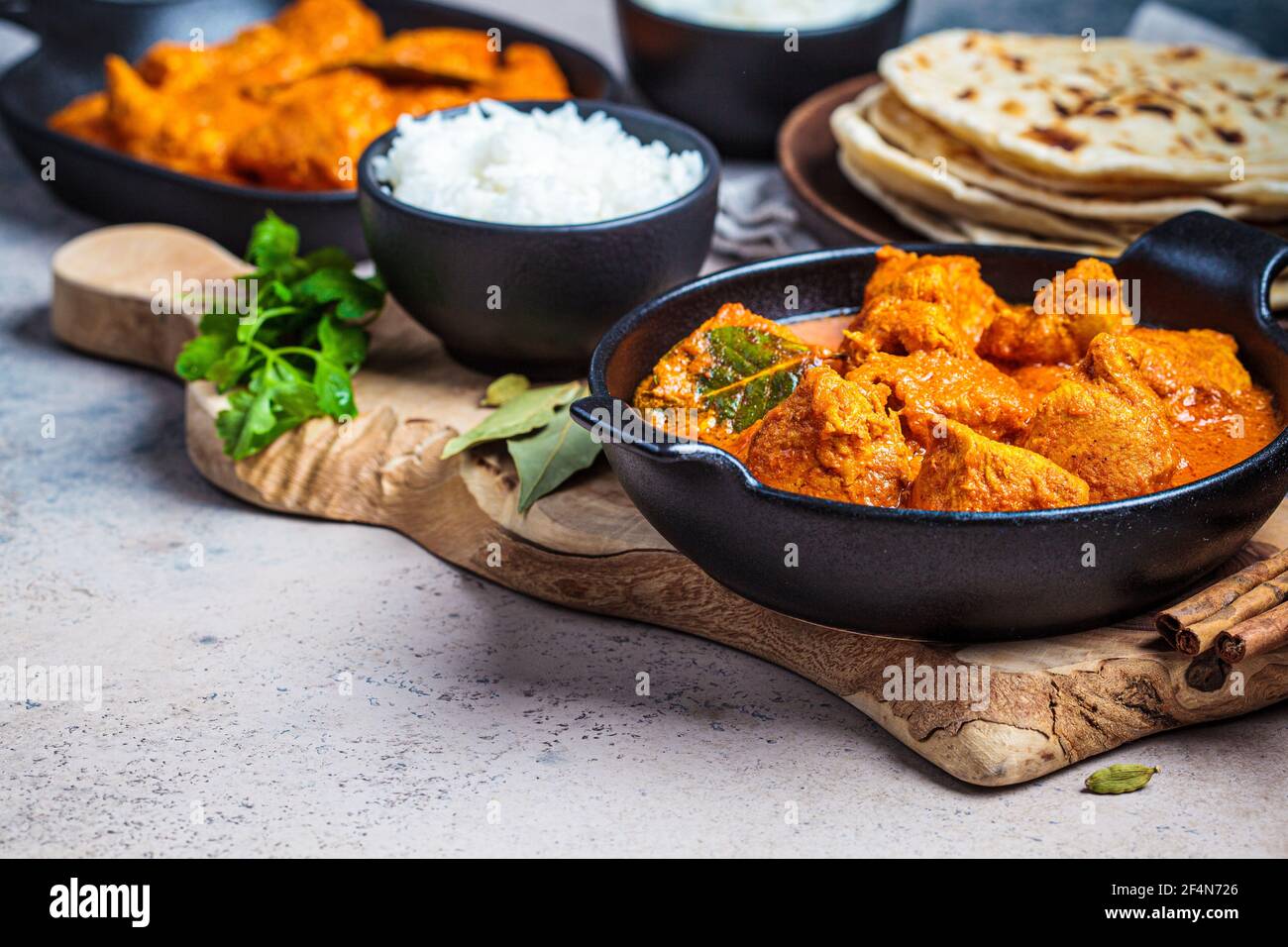 Chicken curry in a spicy sauce with rice and chapati bread, dark ...