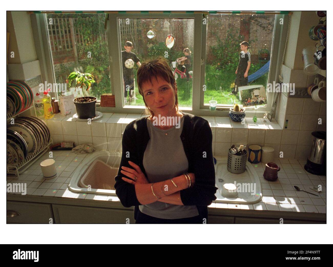 Stepmother Kerry Mac Call with the children playing in the back garden ...