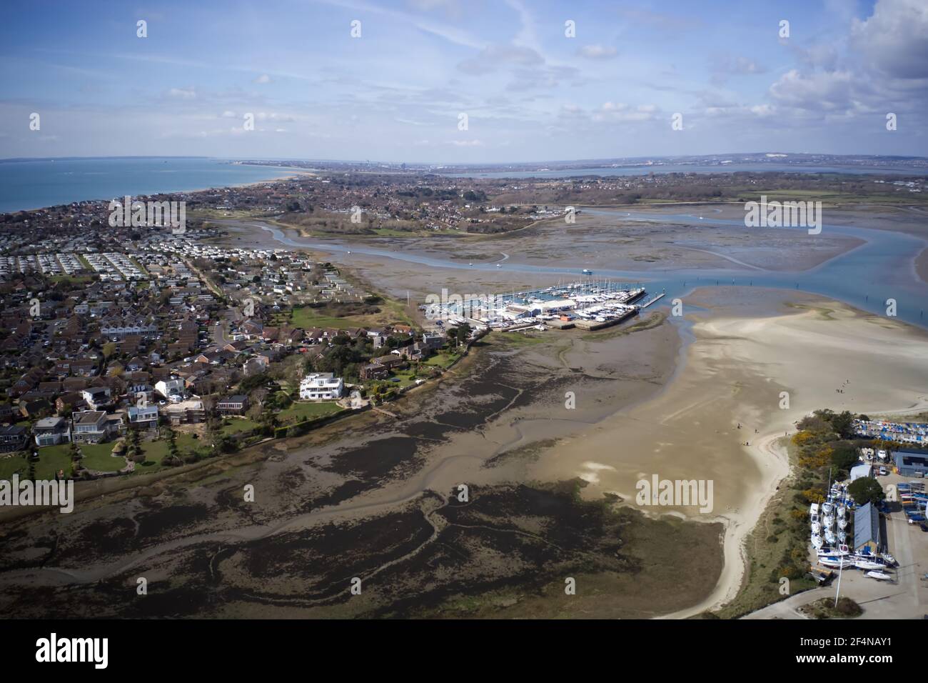 Aerial view of Hayling Island with a marina in view next to the estuary ...