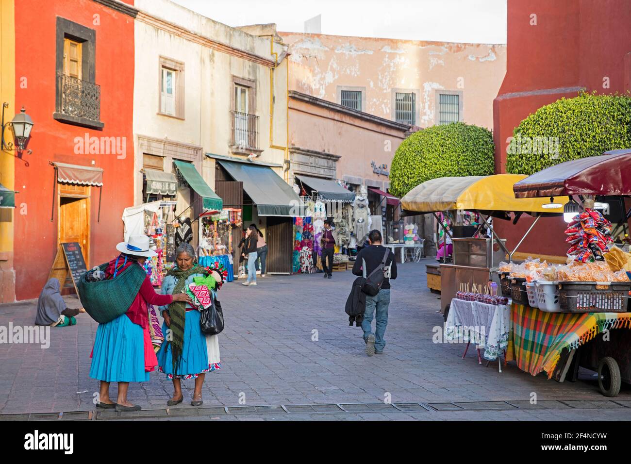 Souvenir shops and native Queretano women in traditional dress in the ...