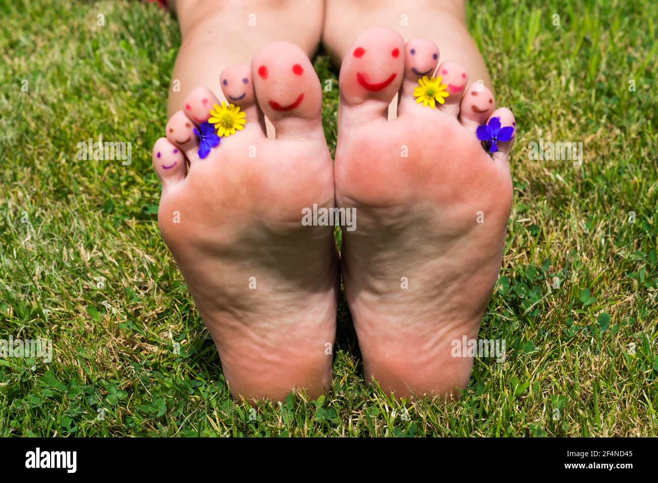 girl has flowers between her feet Stock Photo - Alamy