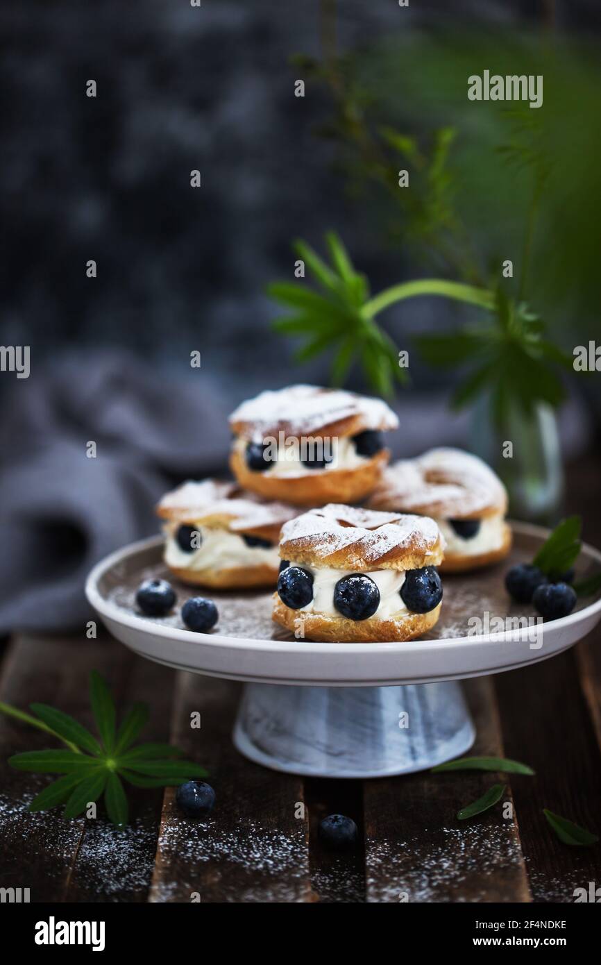 Cream puff rings (choux pastry) decorated with fresh blueberries Stock ...