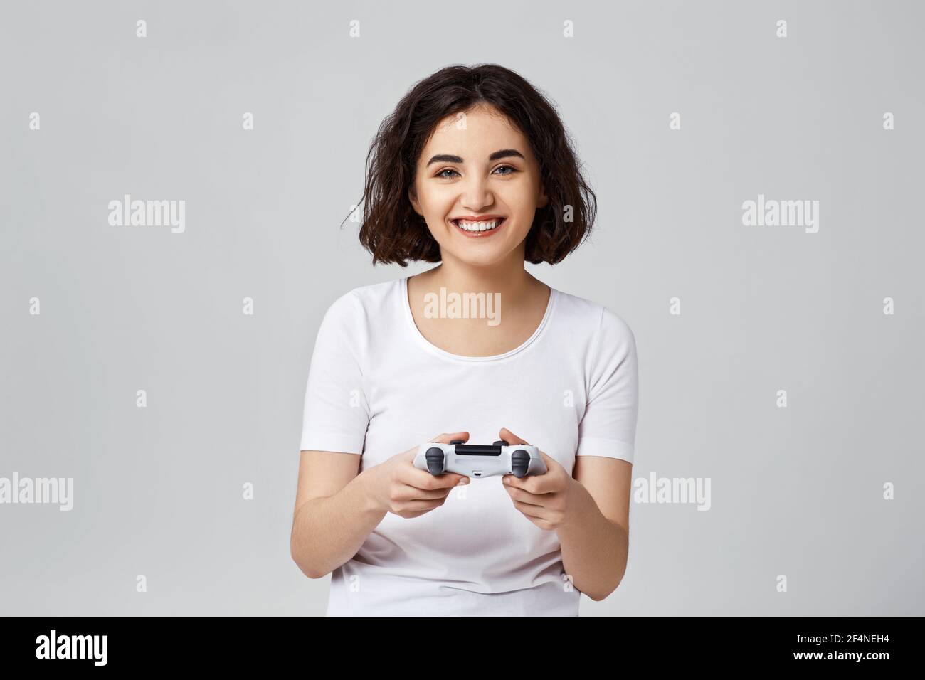 girl playing video games on gray background Stock Photo - Alamy