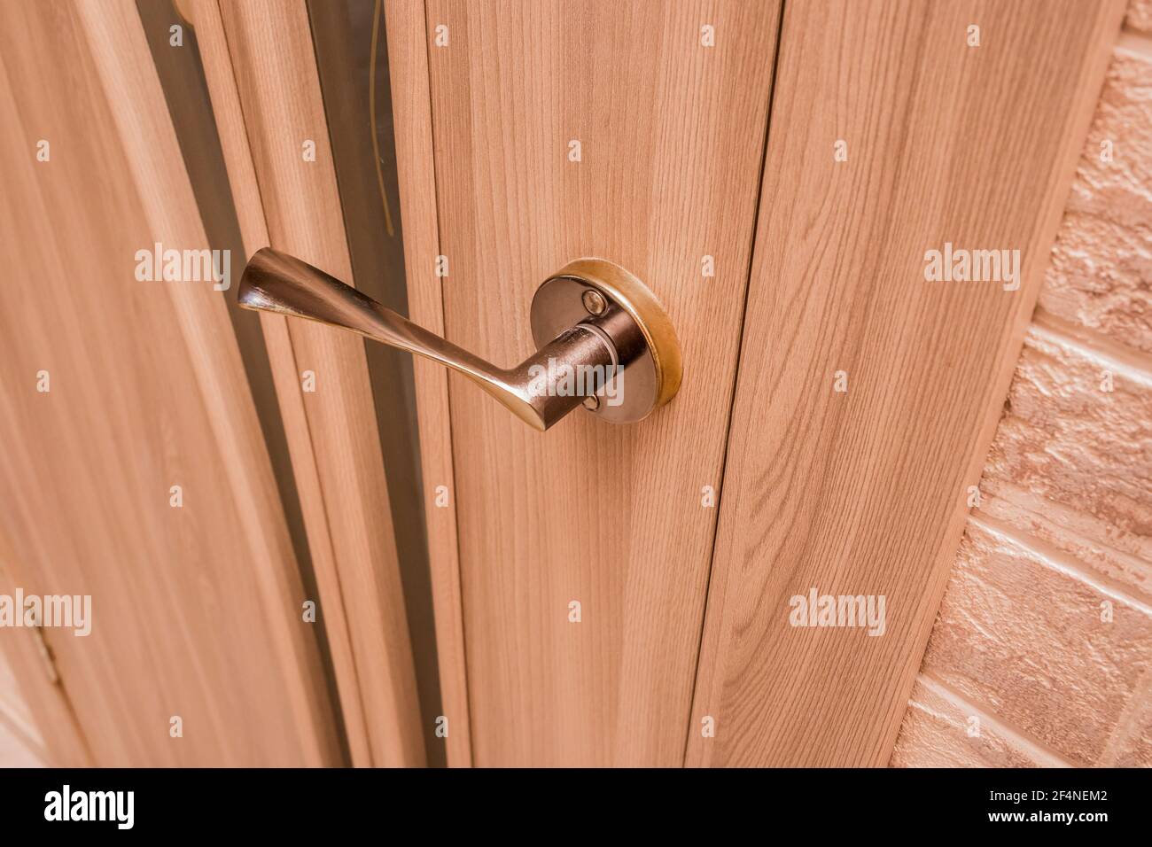 Metal handle wooden door of apartment building close-up Stock Photo - Alamy