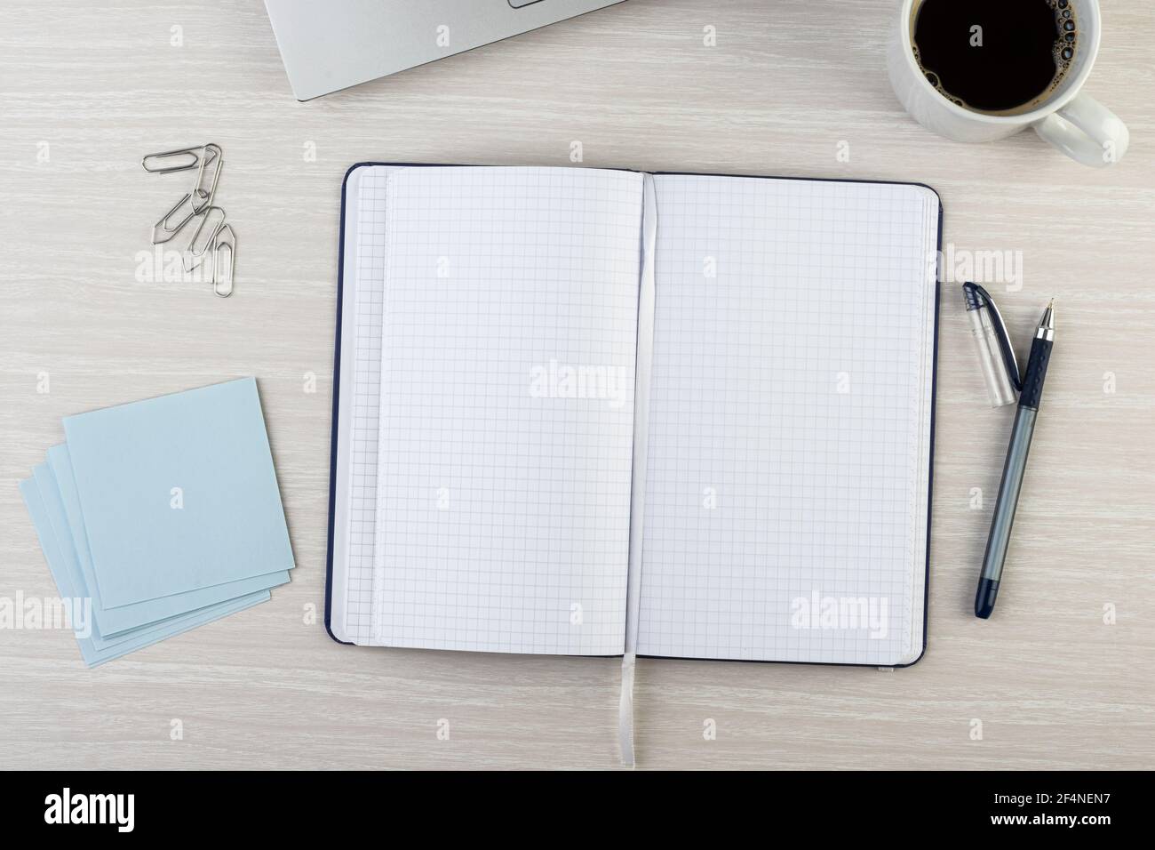 Open blank note book with pen, coffee mug, paper clips and notebook ...
