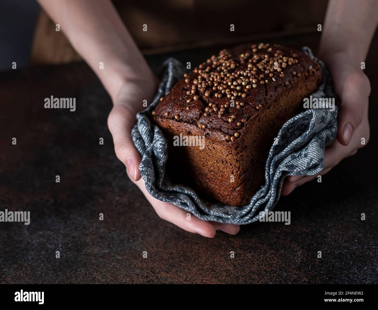 Traditional Russian rye Borodino bread. Female baker holds home made ...
