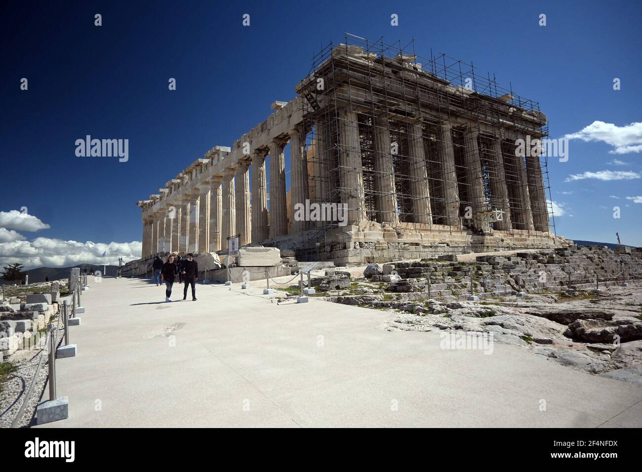 Athens, Greece. 22nd Mar., 2021. Visitors walk past the Temple of ...