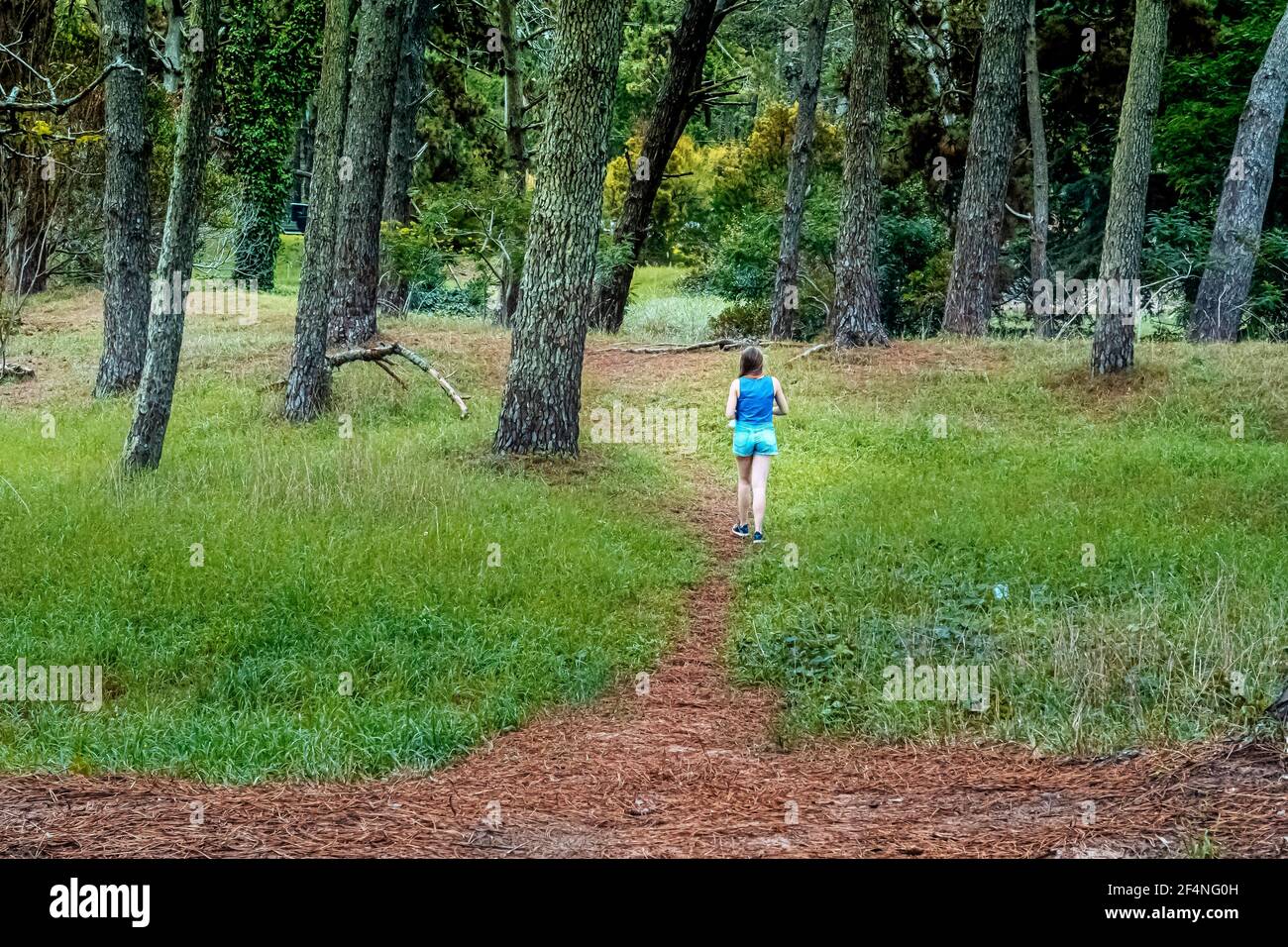 Young Hispanic female from Argentina walking along a pathway in a ...