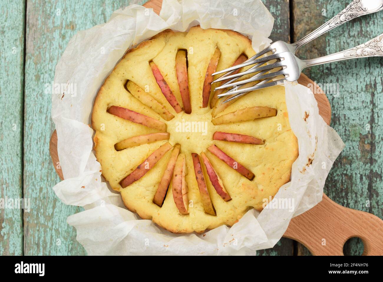 Homemade English round cake with apples freshly baked in paper on robin ...